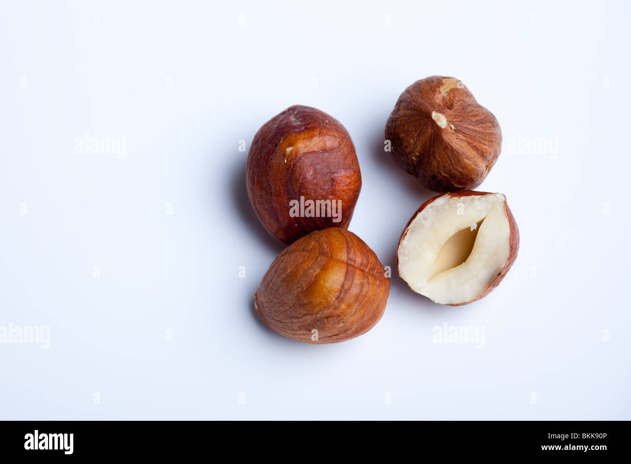 A small pile of hazelnuts with one sliced open Stock Photo - Alamy