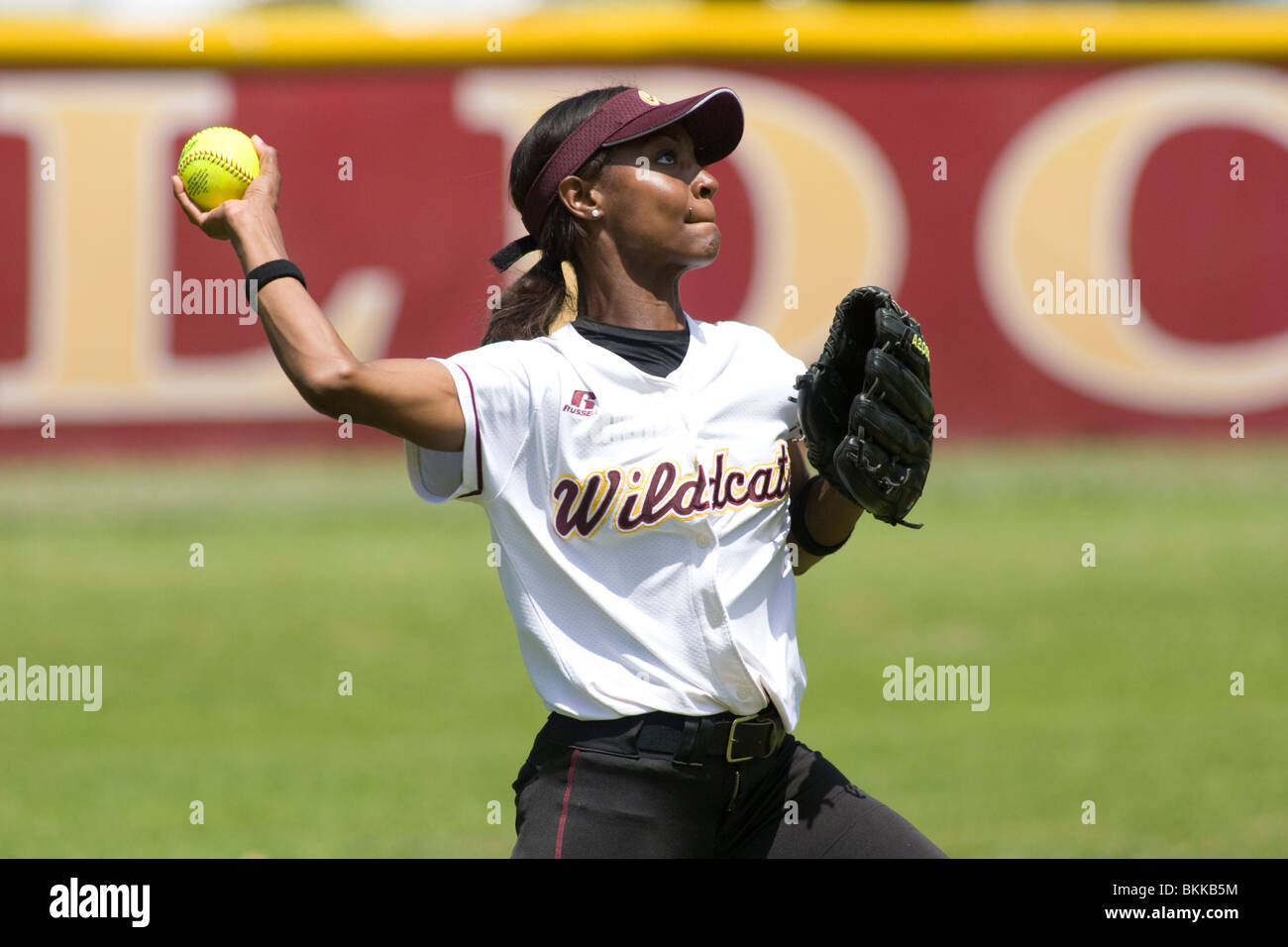 Softball outfielder throwing ball Stock Photo - Alamy