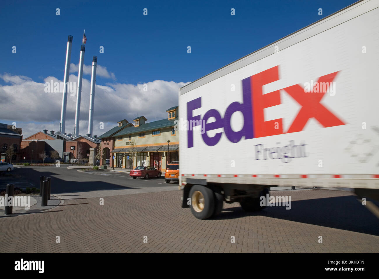 A federal express fedex delivery truck rolls out of a large shopping ...