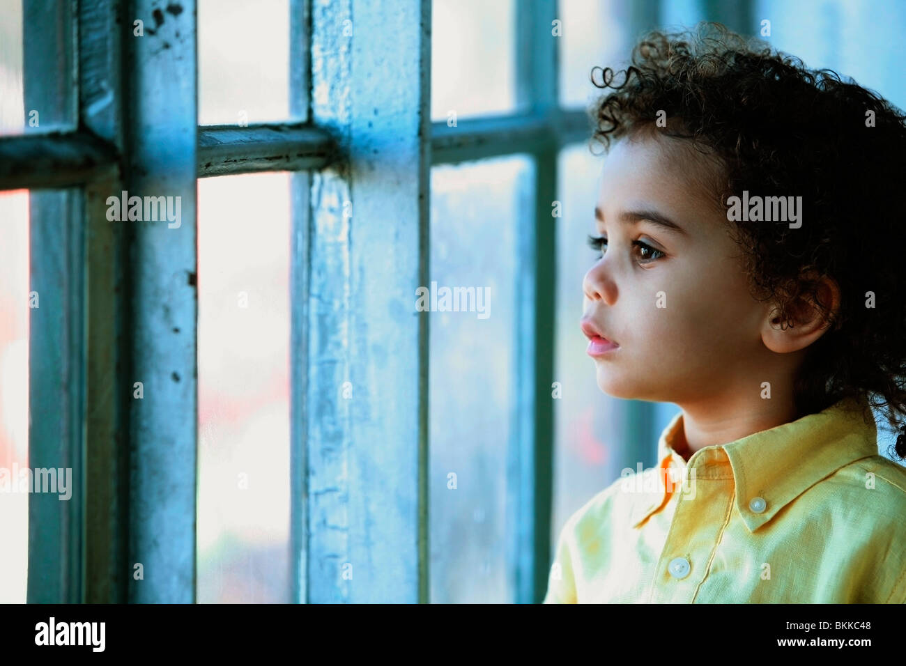 A Young Boy Watching Out The Window Stock Photo - Alamy