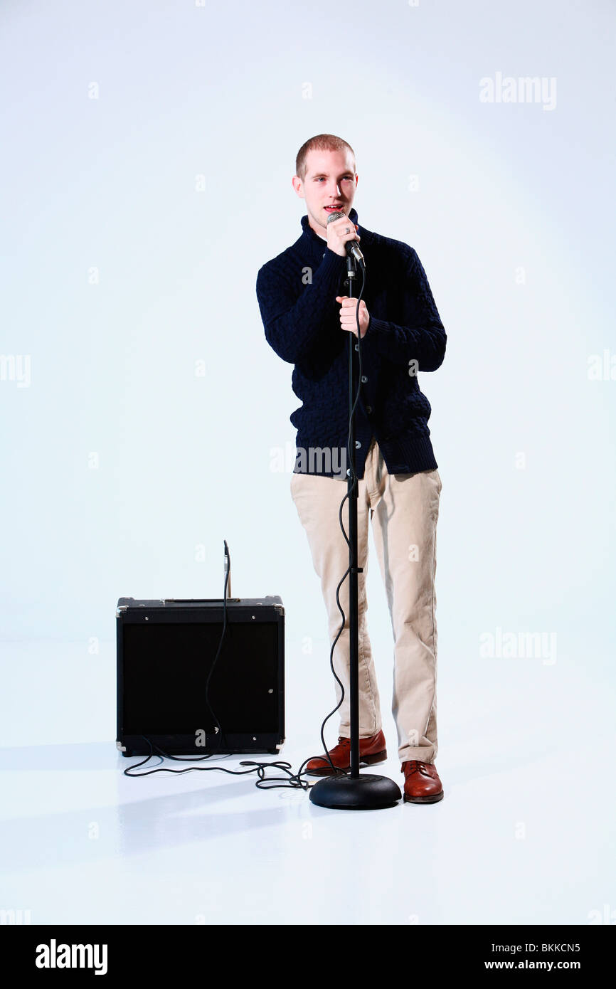 A Young Man Singing Into A Microphone Stock Photo - Alamy