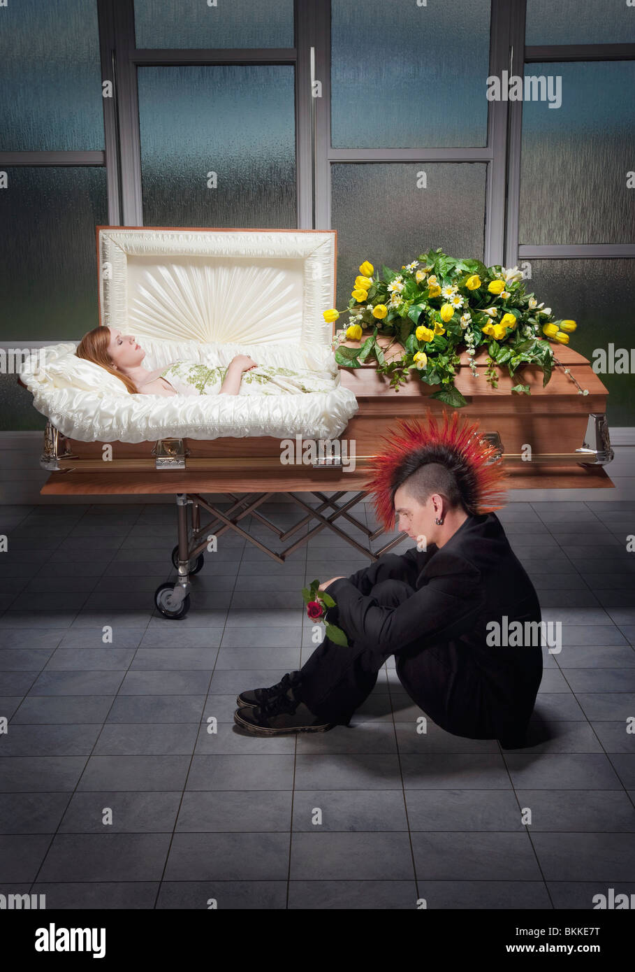 A Young Man Sitting Beside A Coffin With A Young Woman's Body In It ...