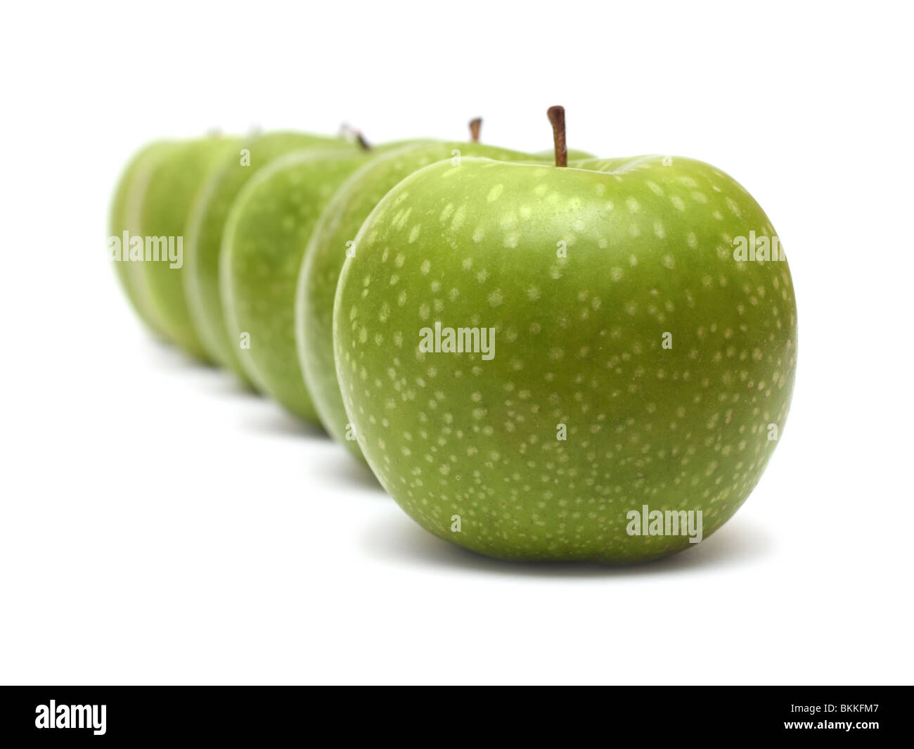 green apples in row isolated on white Stock Photo - Alamy