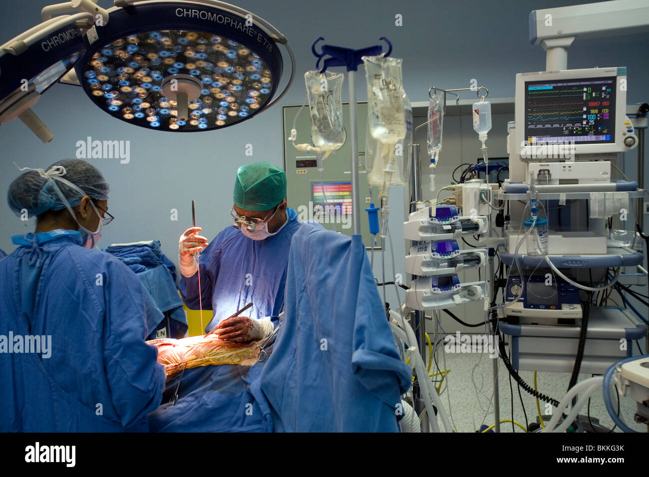 Doctors perform surgery in a state of the art operating theatre in the ...