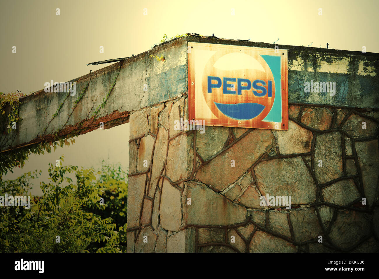 REMNANTS OF AN OLD ROADSIDE BUILDING WITH A RUSTY PEPSI SIGN ON THE ...