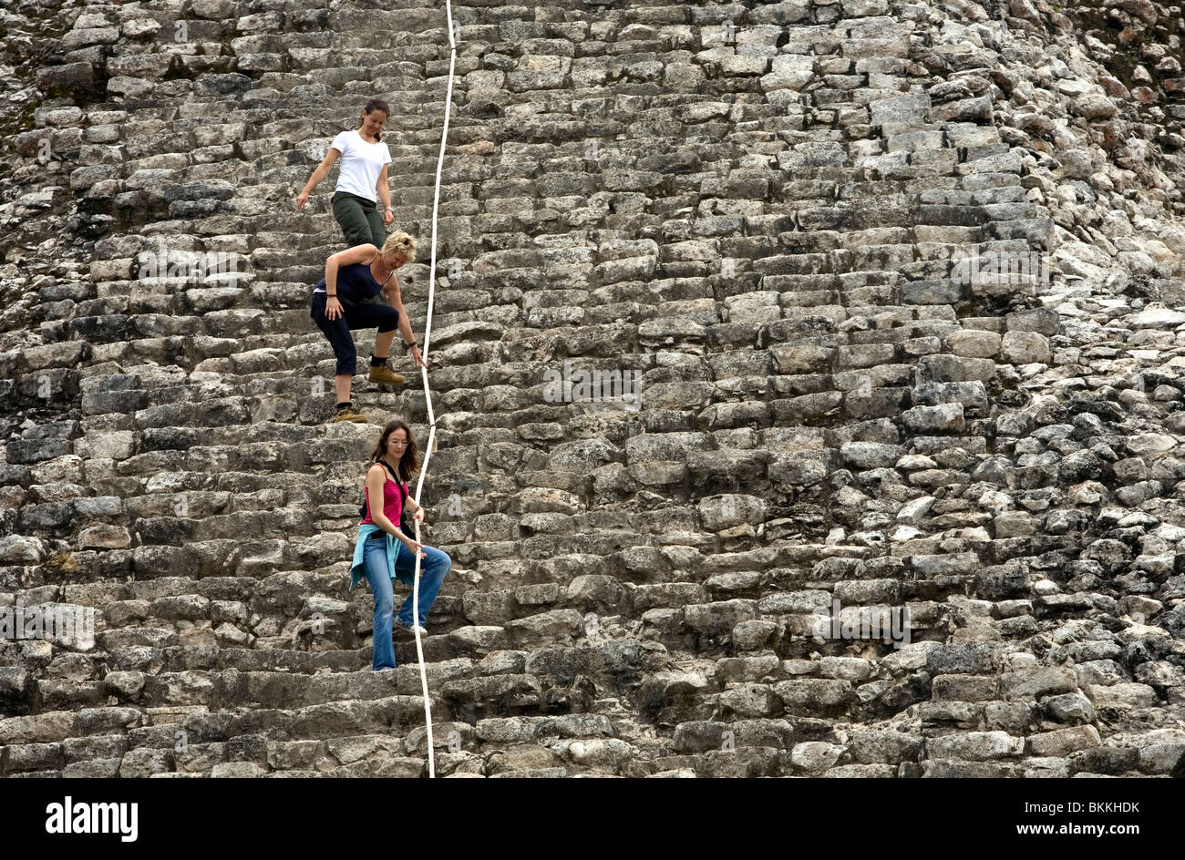 Tourists use a rope to help walk down the Nohoch Mul, the main pyramid ...