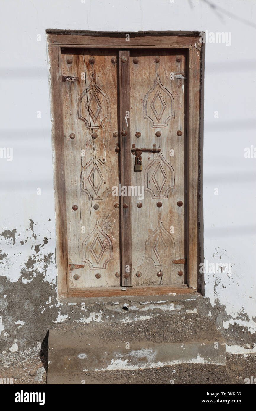 traditional old wooden door in the village of Sur, Sultanat of Oman ...