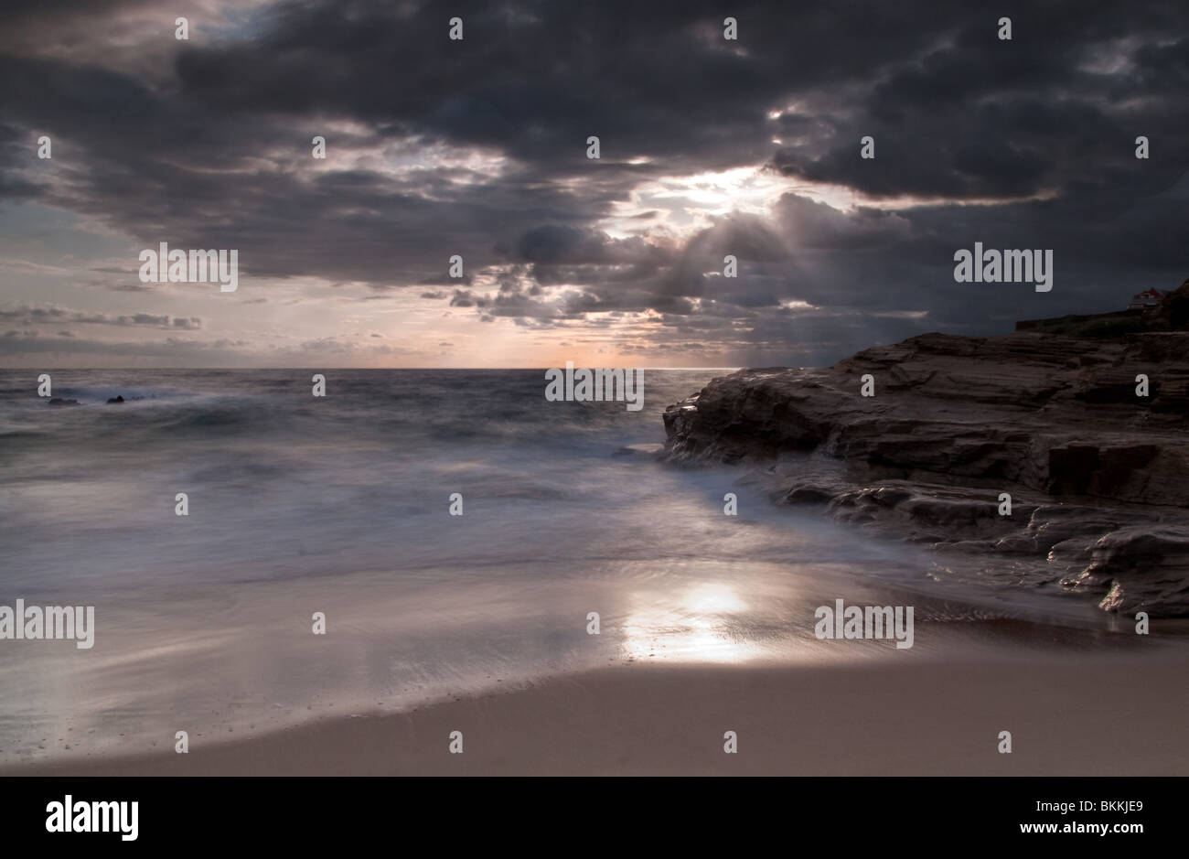 Some beam of the sun hits the water during the sunrise Stock Photo - Alamy