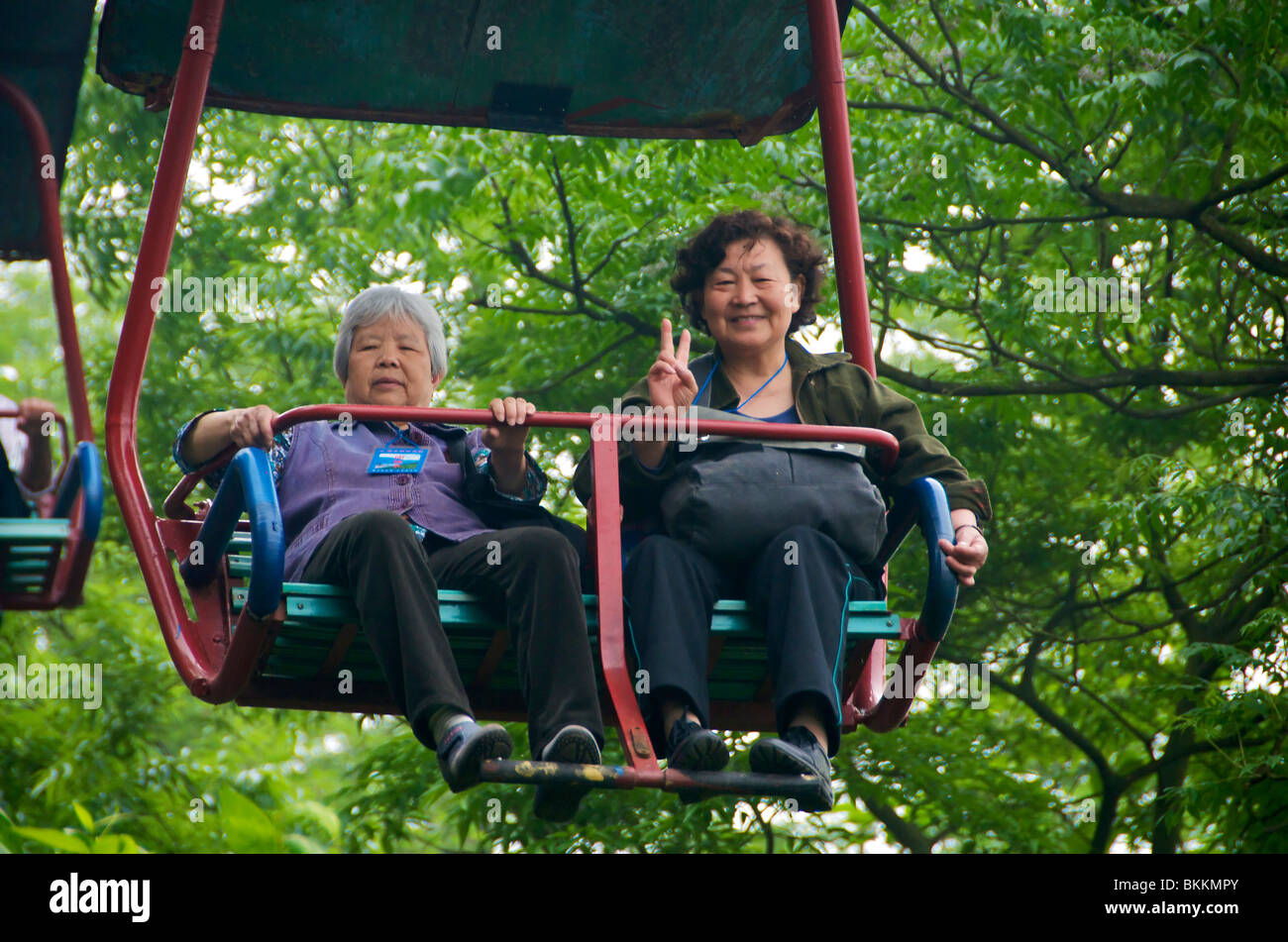 Two Chinese women travelling on chairlift Fengdu Temple beside Yangtze ...
