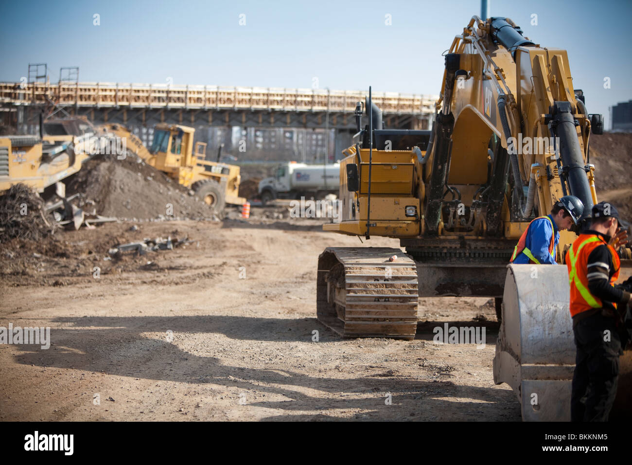 Heavy road construction building equipment work as a team to build a ...