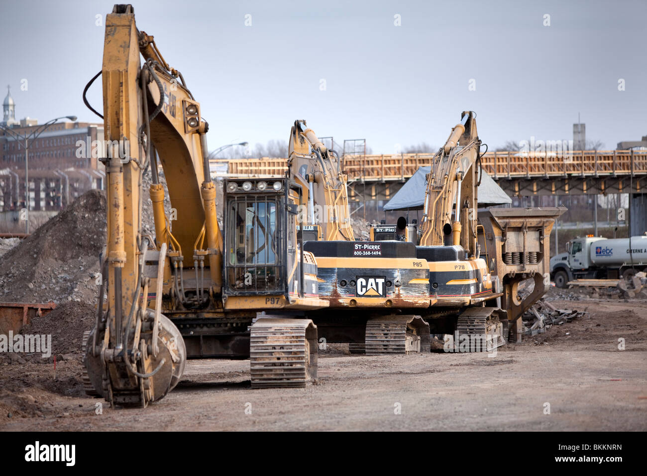 Heavy road construction building equipment work as a team to build a ...