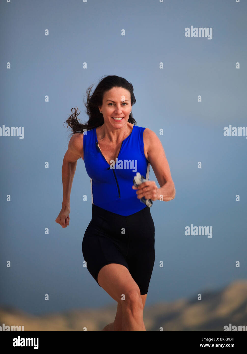 Female triathlete running beach hi-res stock photography and images - Alamy
