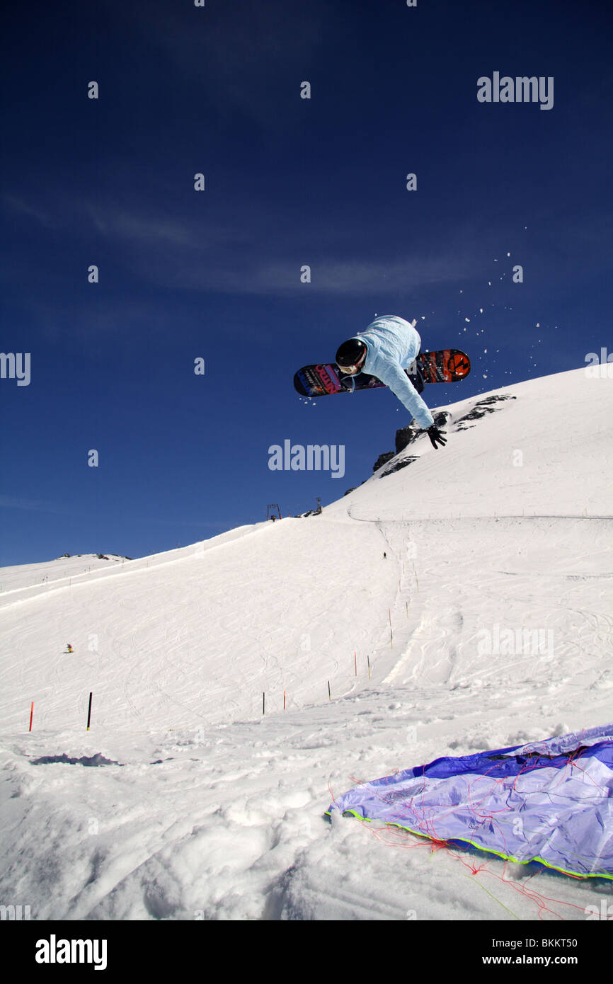 Professional Snowboarder performs a freestyle mid air stunt Stock Photo ...