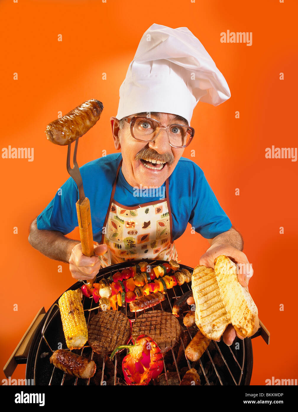 Man cooking at bar-b-que Stock Photo - Alamy