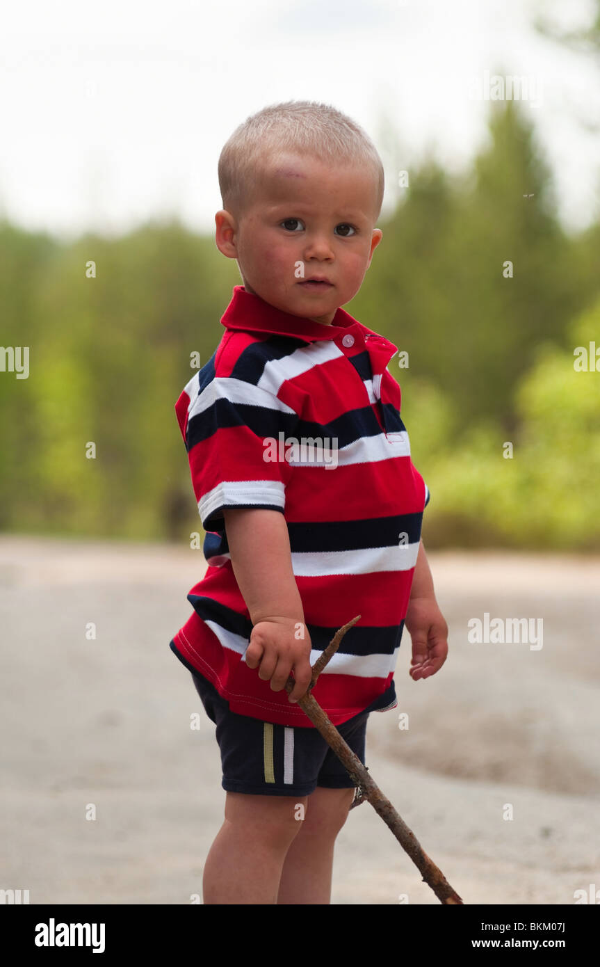 One little rascal boy with stick walking on outdoor in nature Stock ...
