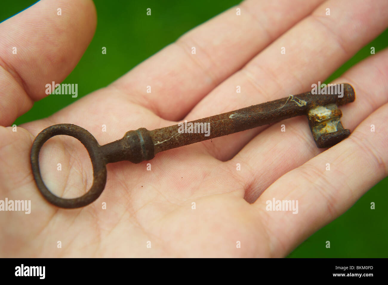 Old rusty key in open hand Stock Photo - Alamy