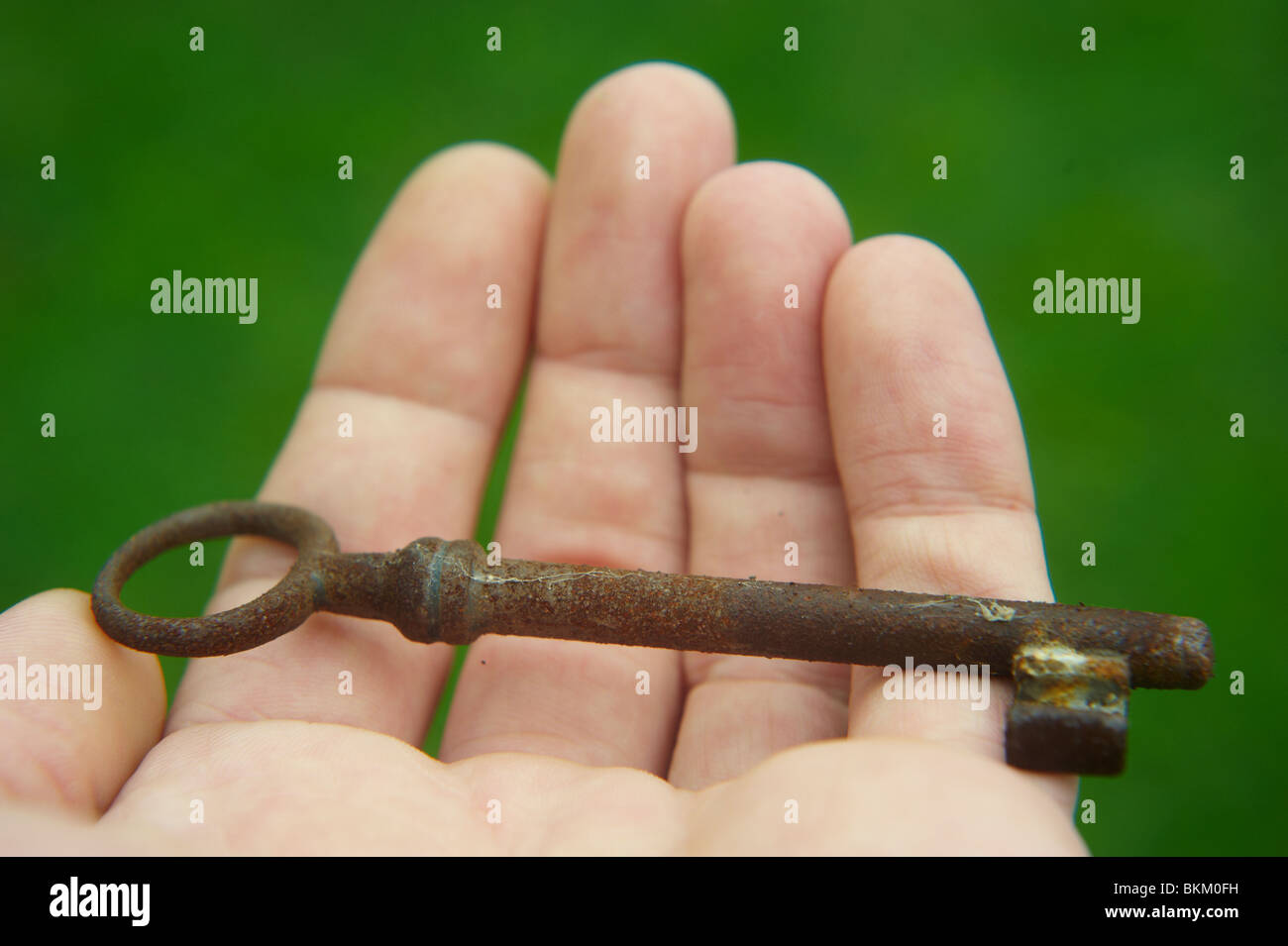 Old rusty key in open hand Stock Photo - Alamy