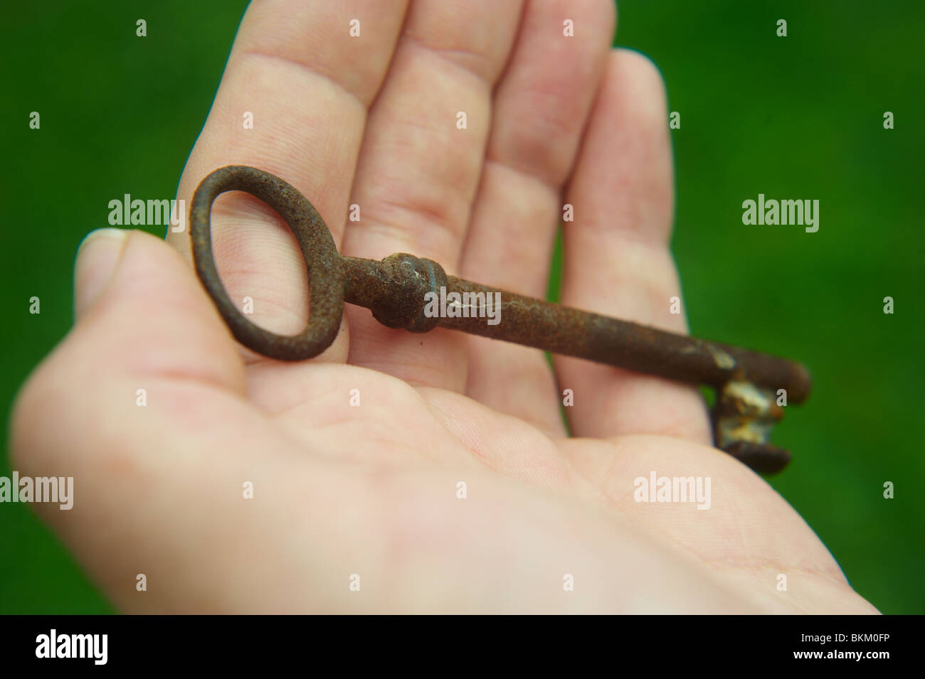 Old rusty key in open hand Stock Photo - Alamy