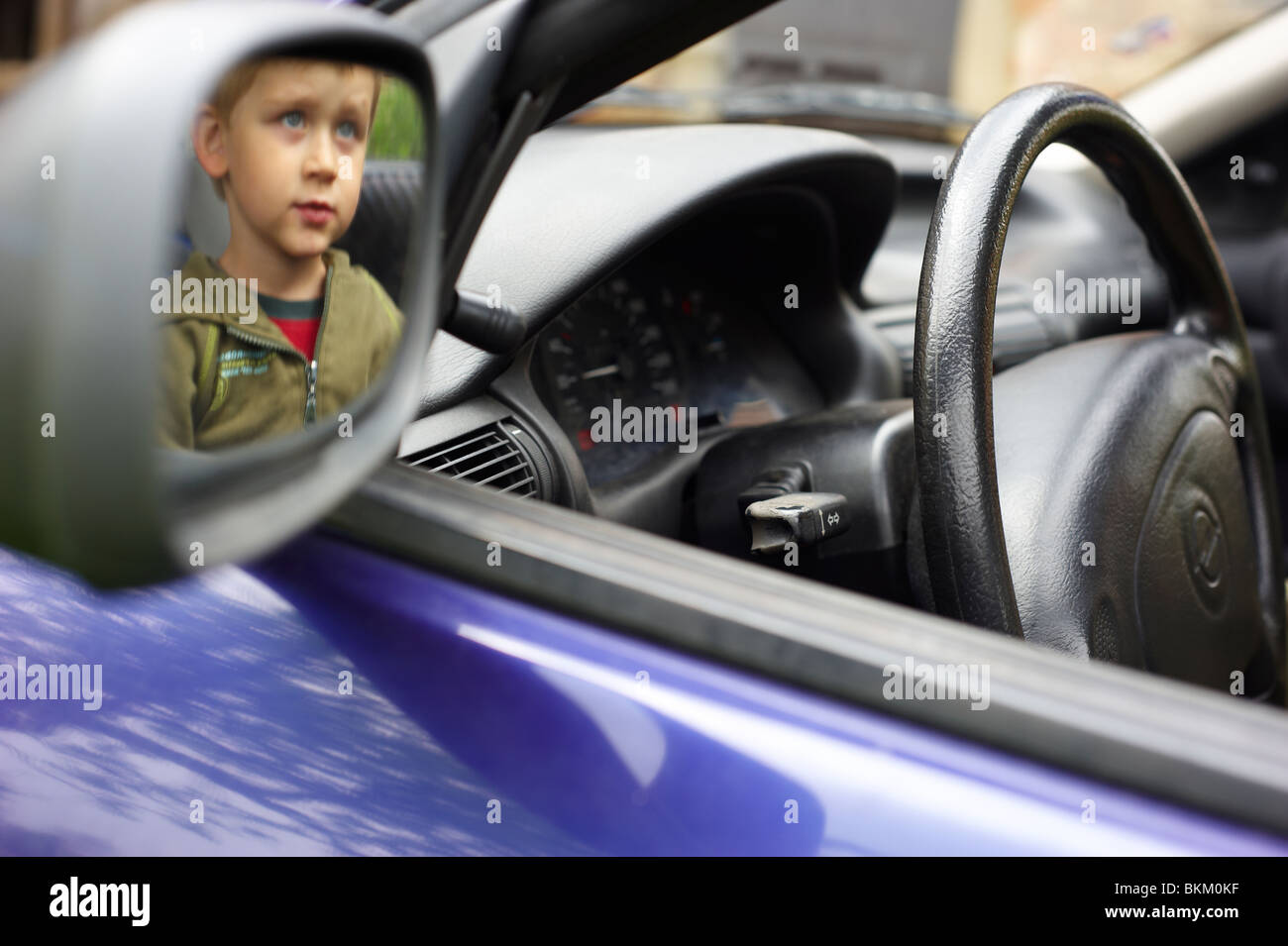 Child blond boy driving - playing real car Stock Photo - Alamy