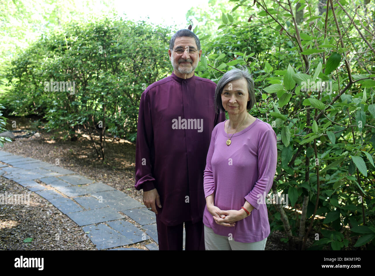 Two people standing in a garden Stock Photo - Alamy