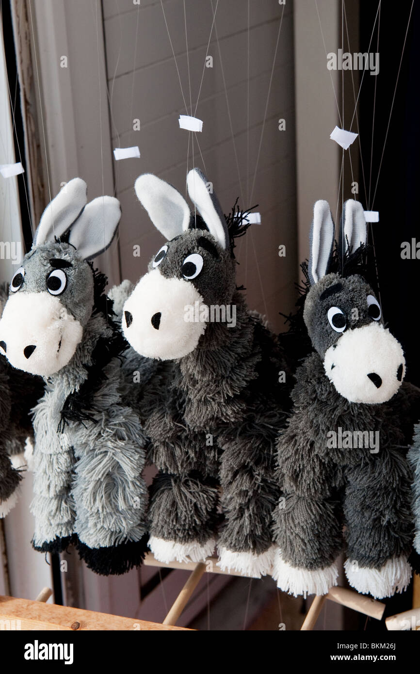 Souvenir donkeys in gray hanging near the shops Stock Photo - Alamy