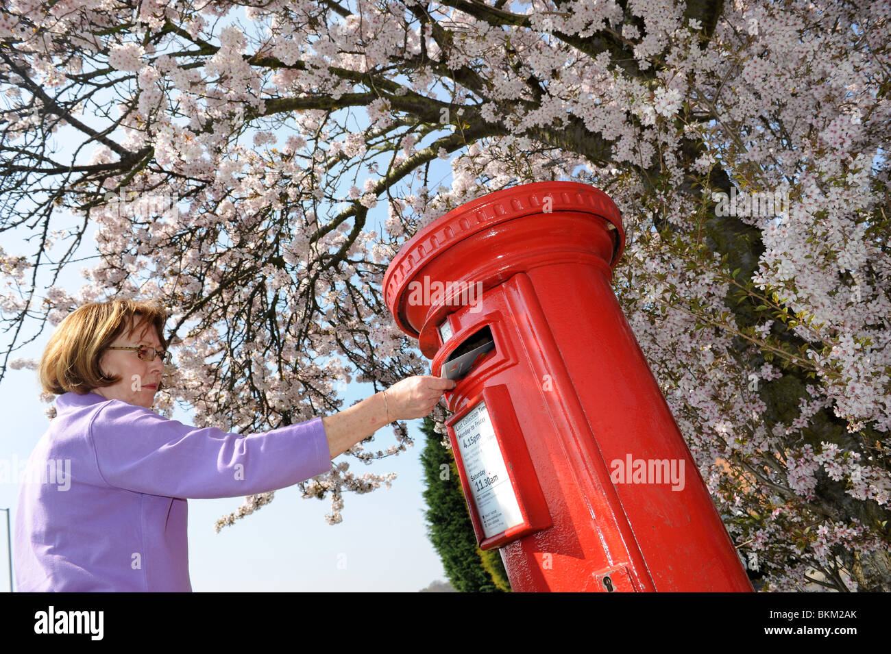 Woman posting letter in post hi-res stock photography and images - Alamy