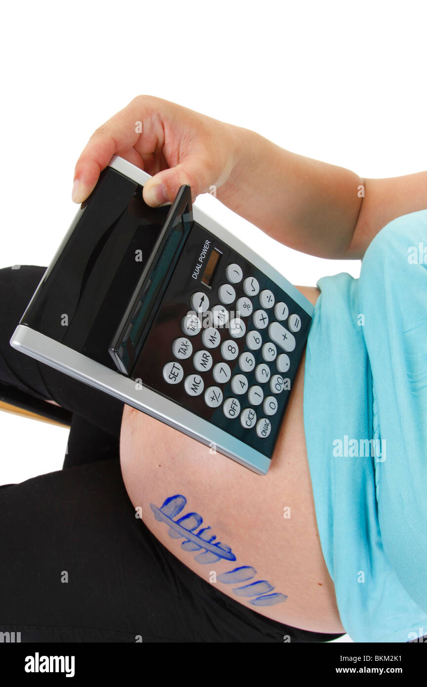pregnant woman calculates the days to birth with a calculator and ...