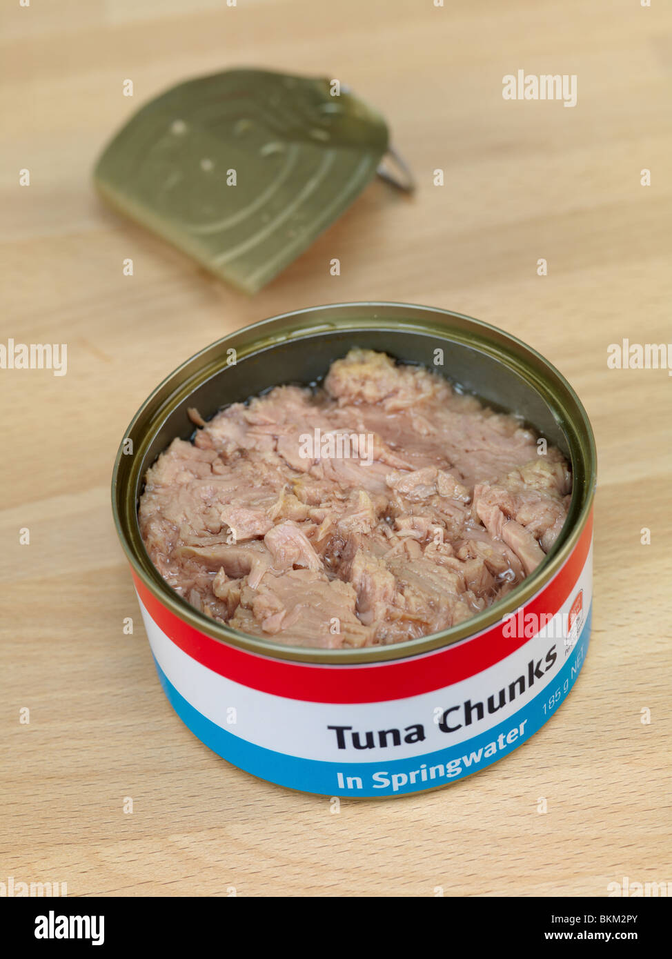 Cans of Tuna isolated on a wooden kitchen bench Stock Photo - Alamy