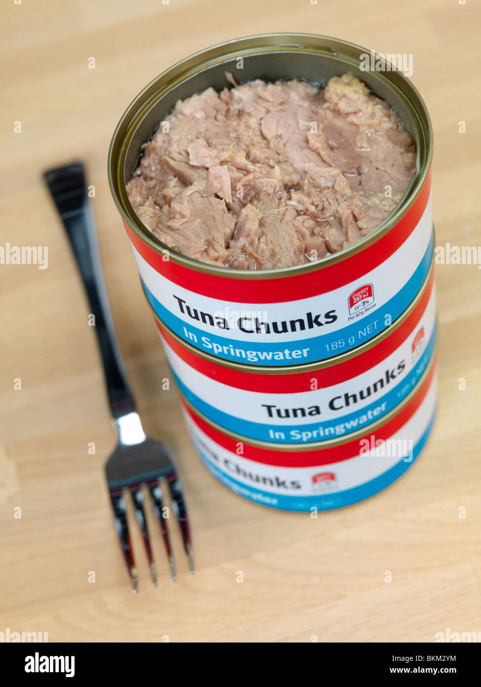 Cans of Tuna isolated on a wooden kitchen bench Stock Photo - Alamy