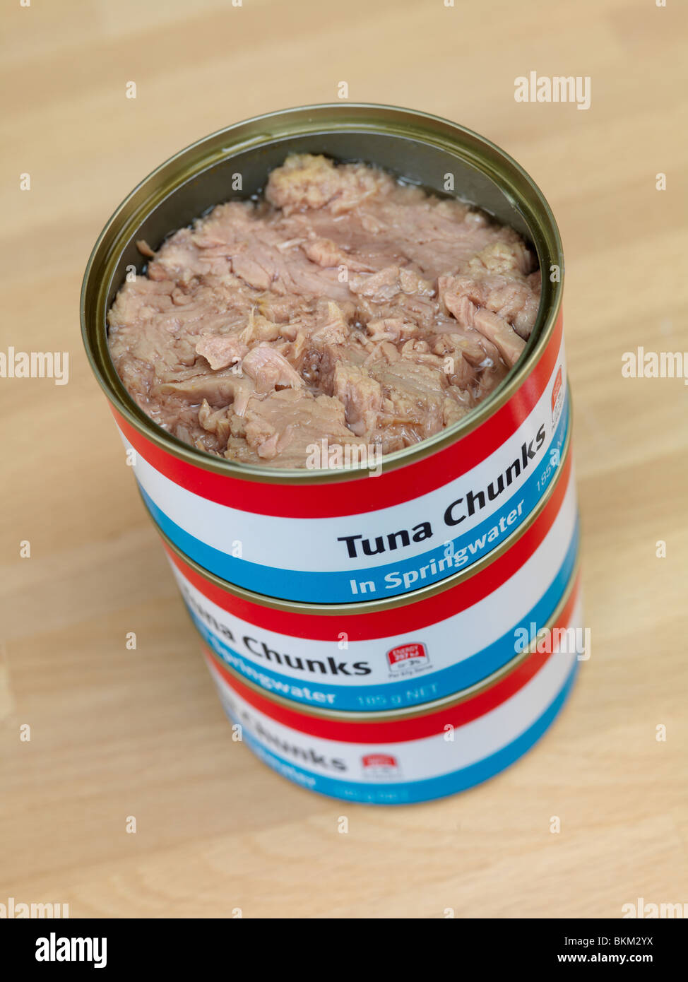 Cans of Tuna isolated on a wooden kitchen bench Stock Photo - Alamy