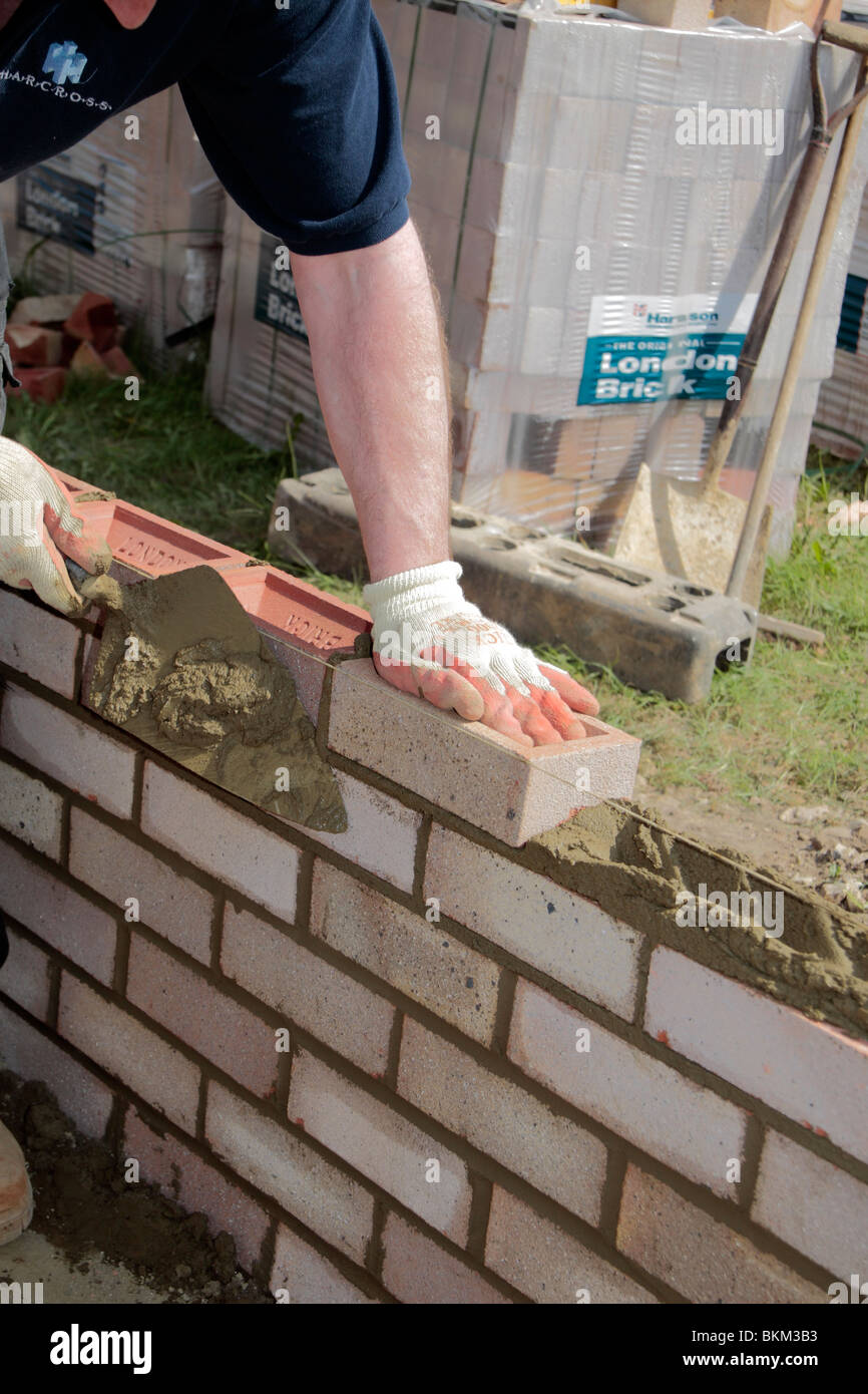 Laying bricks hands hi-res stock photography and images - Alamy