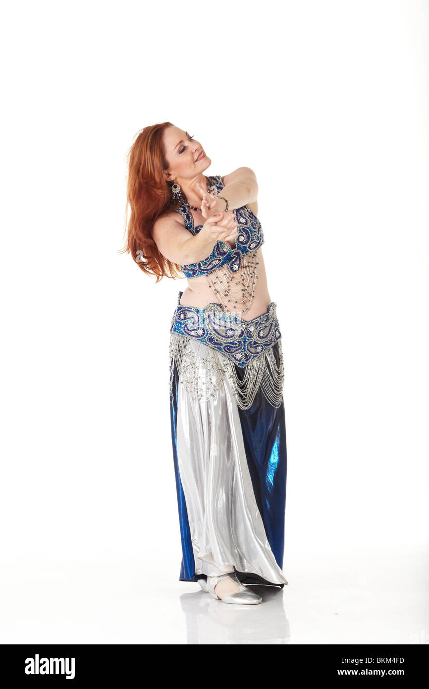 adult caucasian belly dancer with red hair and a blue belly dancing ...