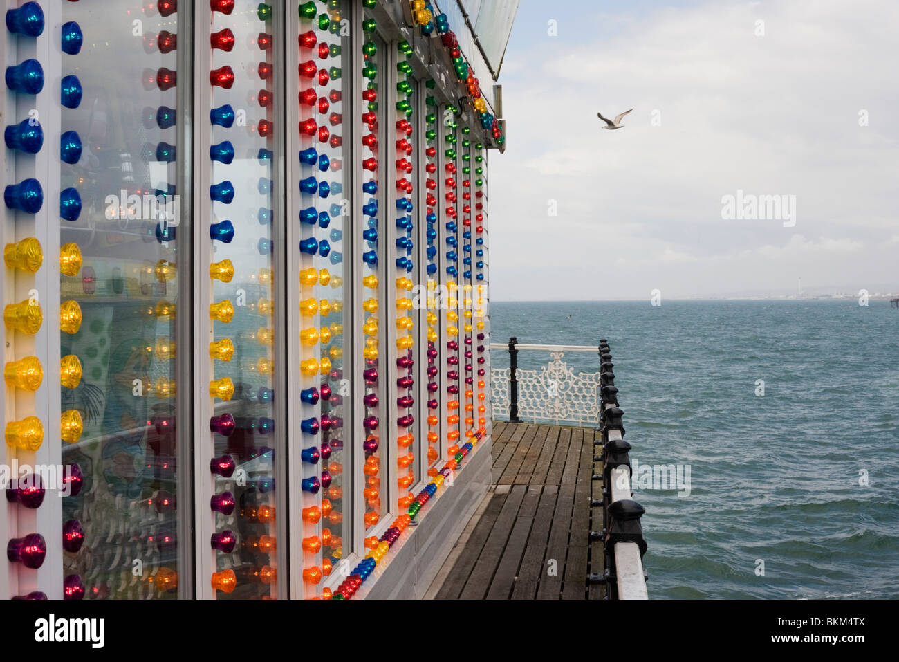 Brighton pier amusement arcade lights with the sea horizon beyond Stock ...