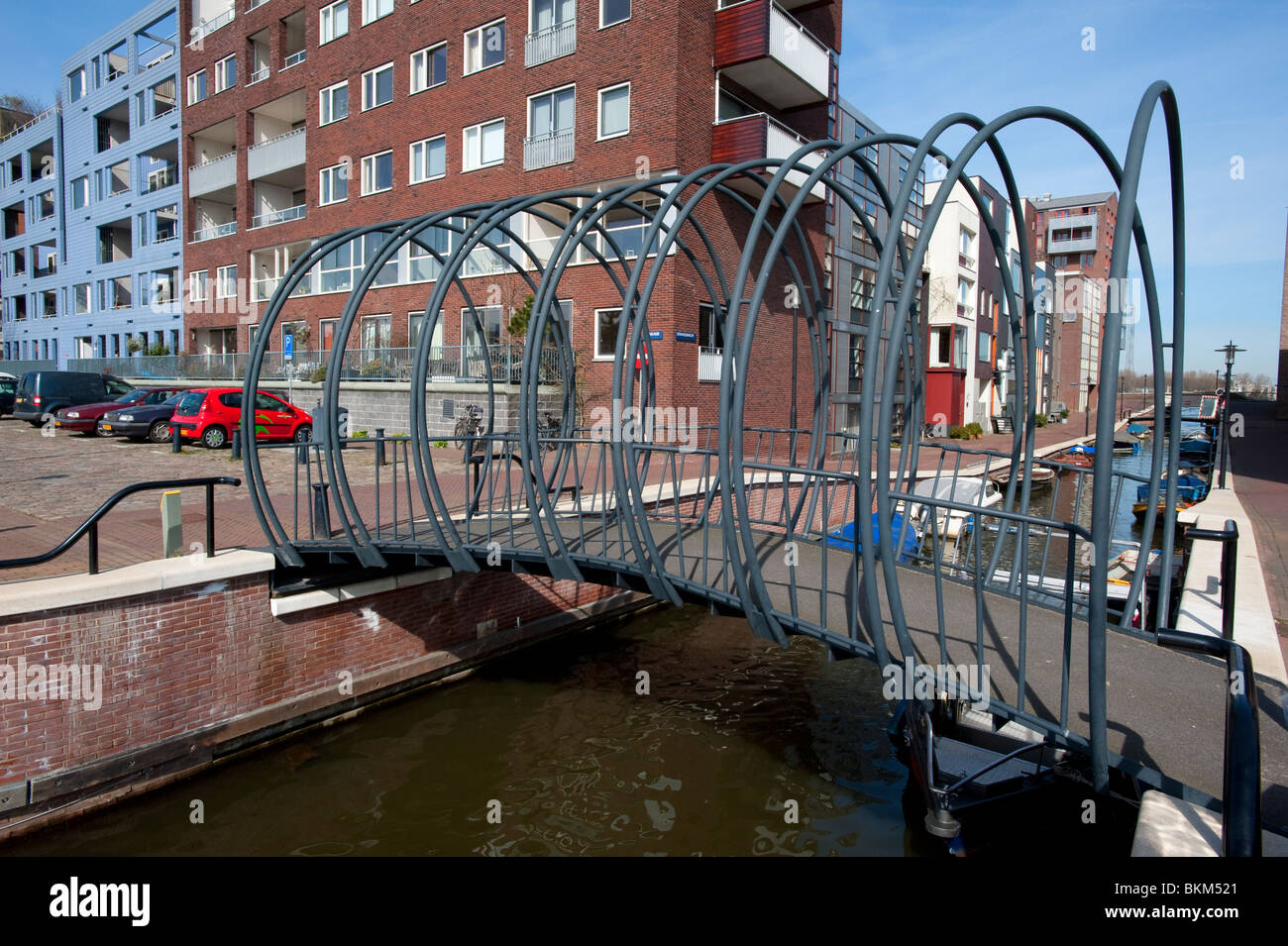 modern steel footbridge over canal in new Java Island housing ...