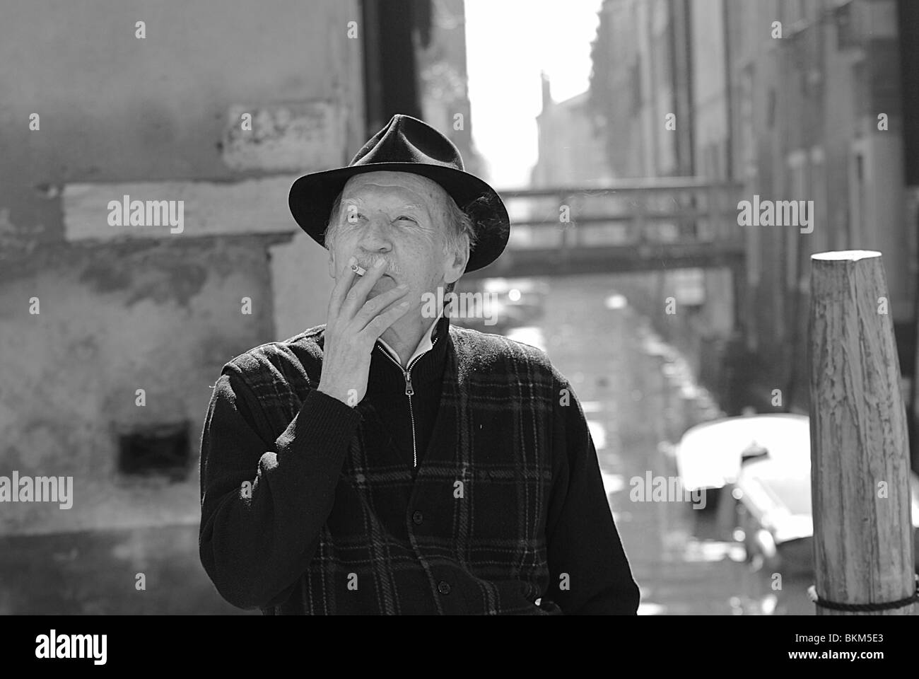 Black and white portrait of an elederly Italian man smoking a cigarette ...