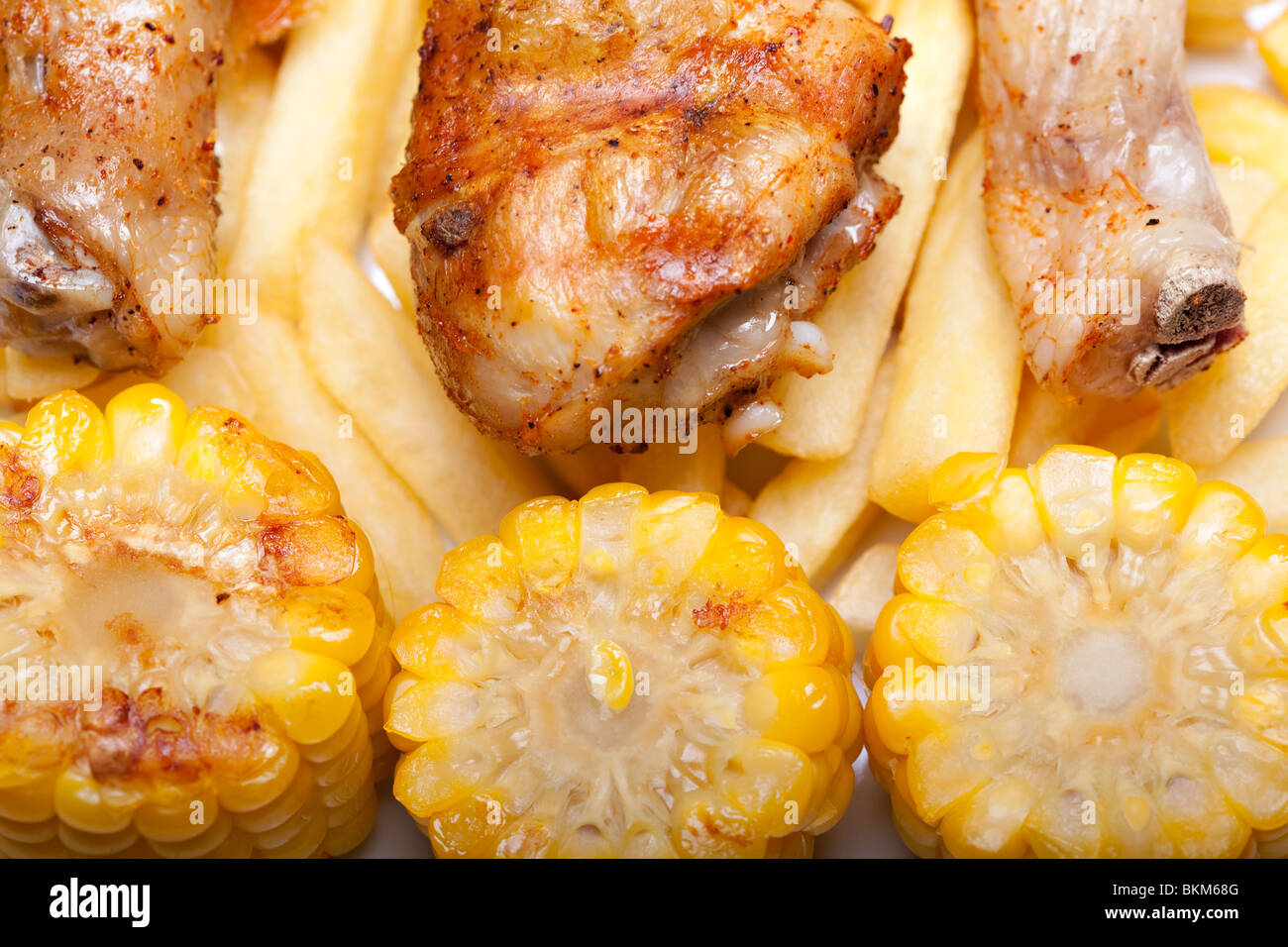 grilled chicken leg and chips Stock Photo - Alamy