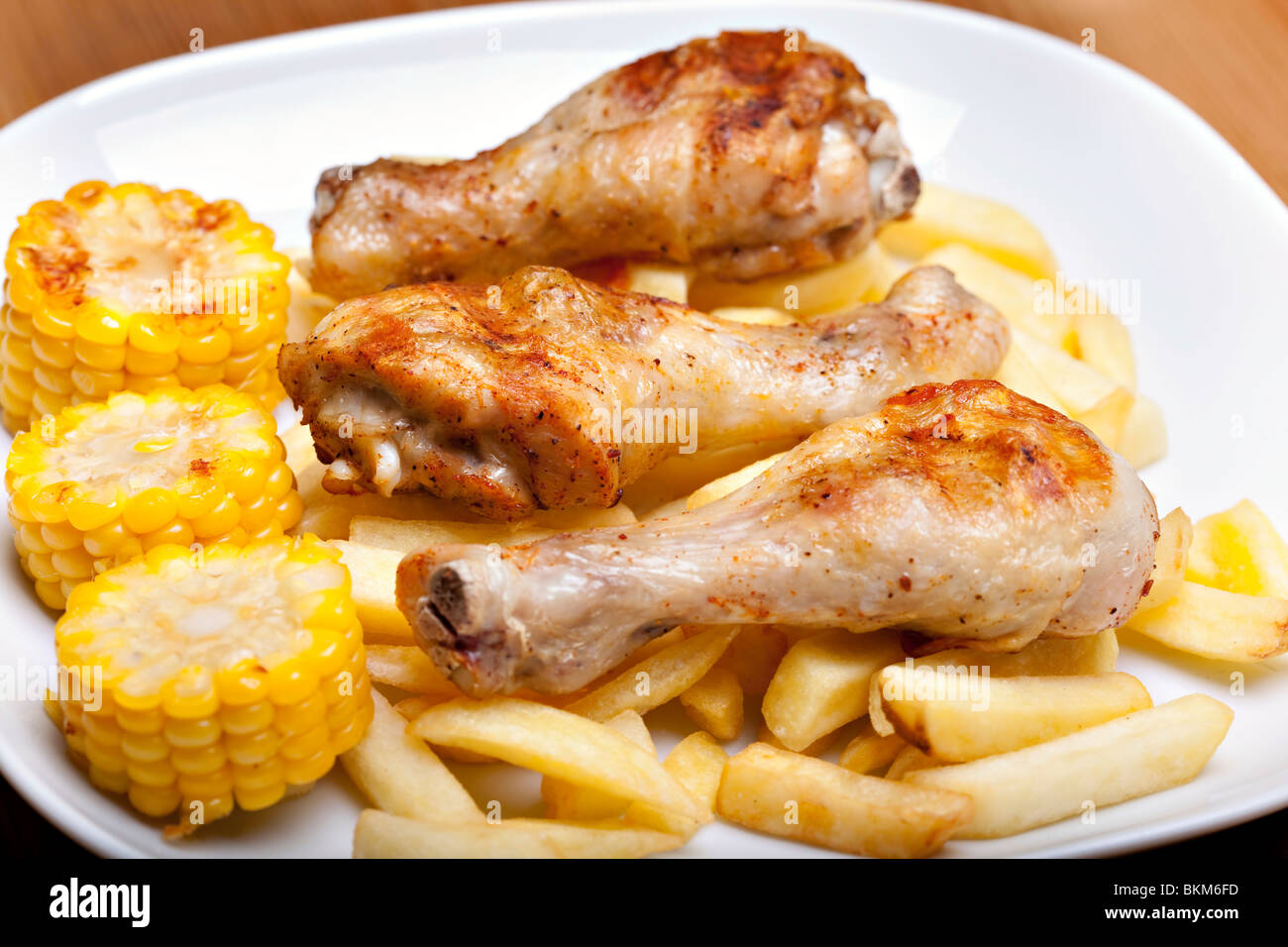 grilled chicken leg and chips Stock Photo - Alamy