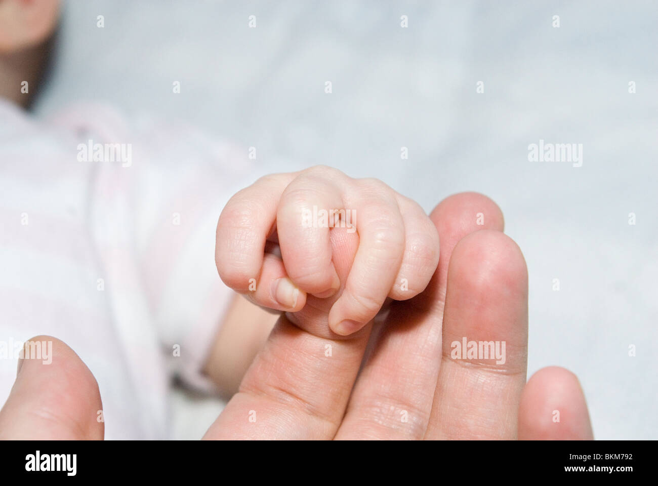 Close Up on Tiny Hand OF Baby Girl Holding Mummys Finger Stock Photo ...