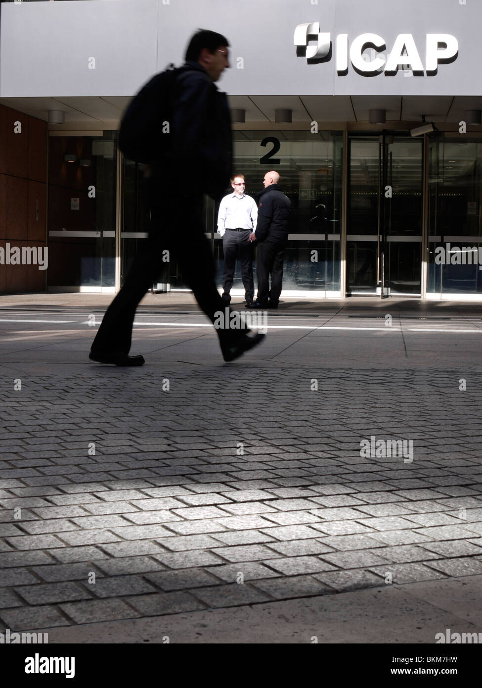 A pedestrian walks past the ICAP headquarters at Broadgate, London, UK ...