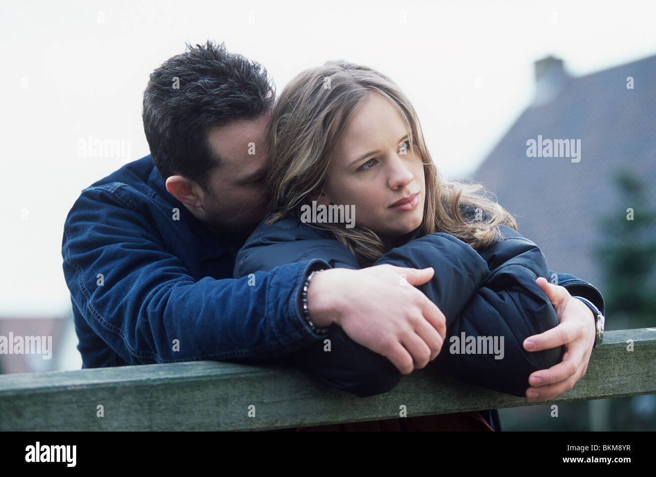 Sad young adult outside contemplating in winter wear Stock Photo - Alamy