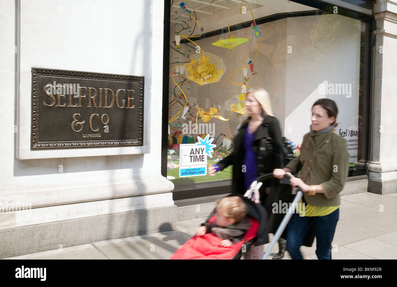Shoppers walk past the store sign, Selfridges department store, Oxford ...