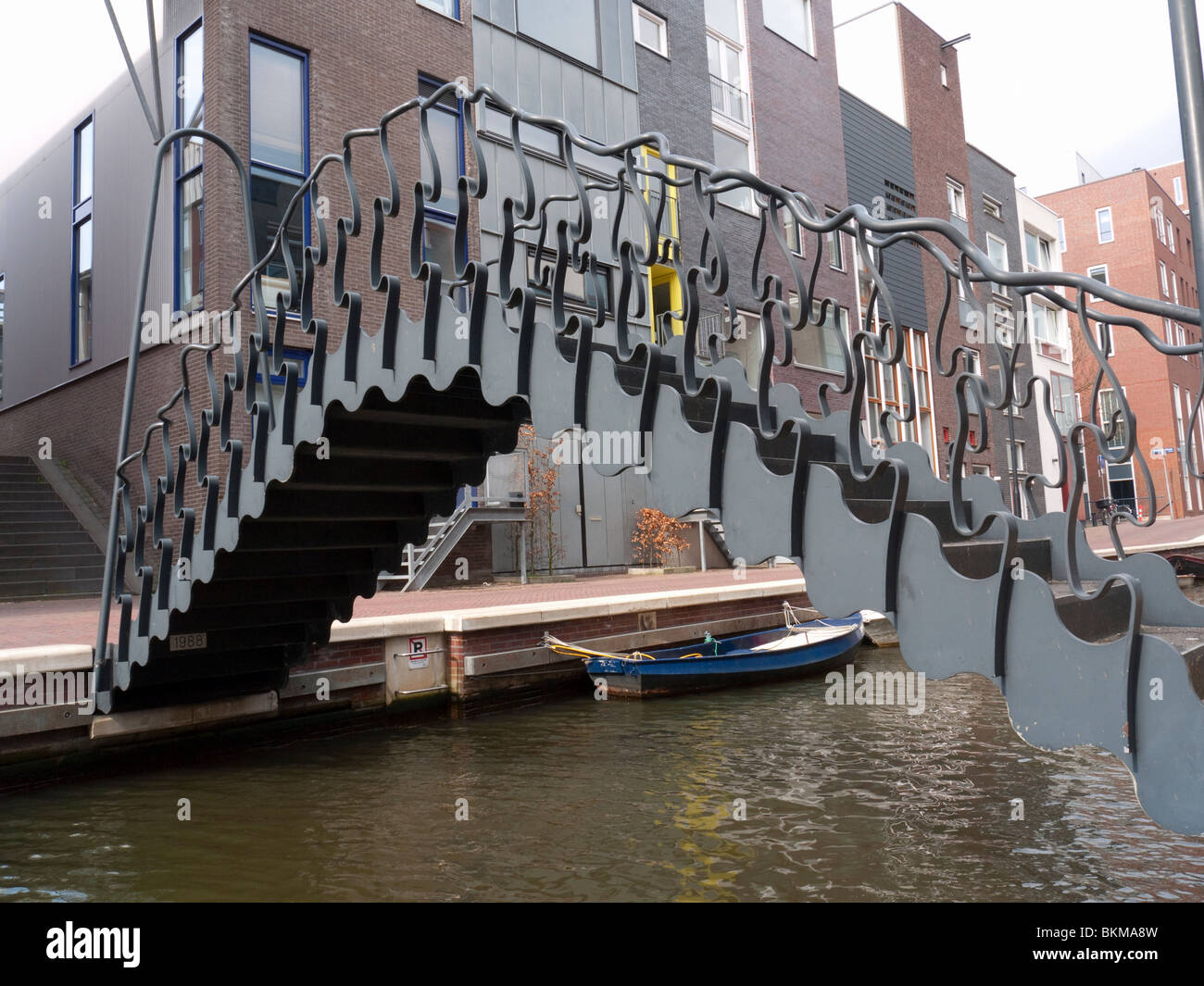 Modern ornate steel footbridge crossing canal in new Java Island ...