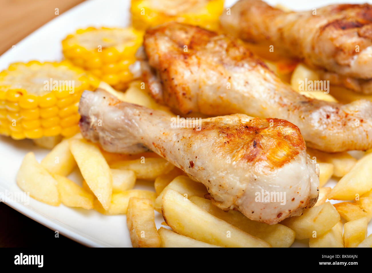 grilled chicken leg and chips Stock Photo - Alamy