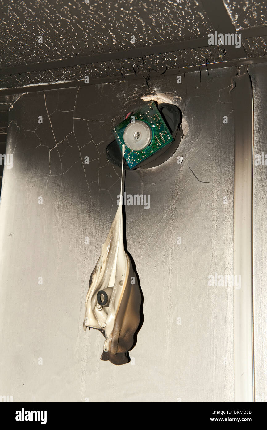 Melted smoke alarm following serious fire Stock Photo - Alamy