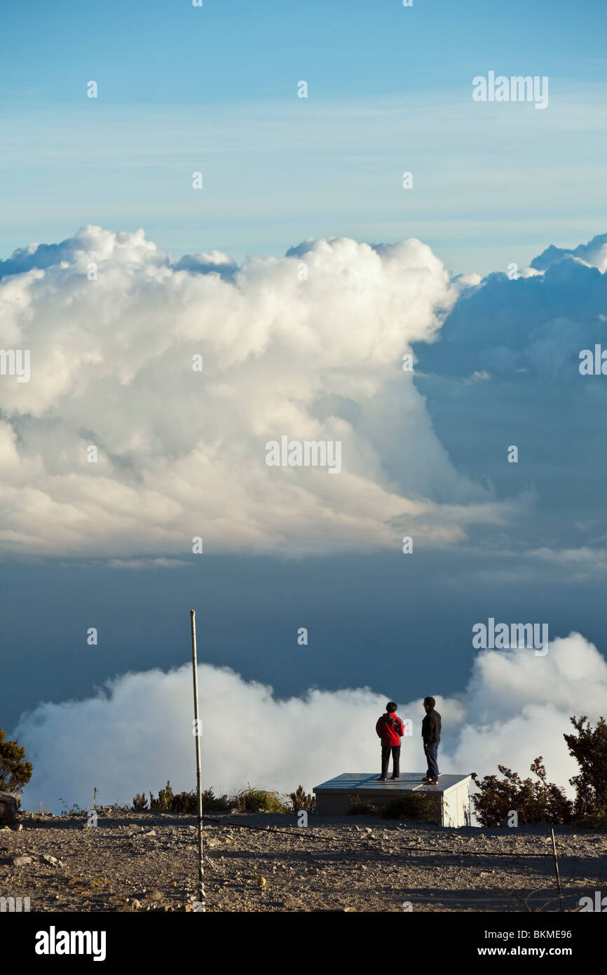 Hikers look out over the clouds from Laban Rata, on the Mt Kinabalu ...