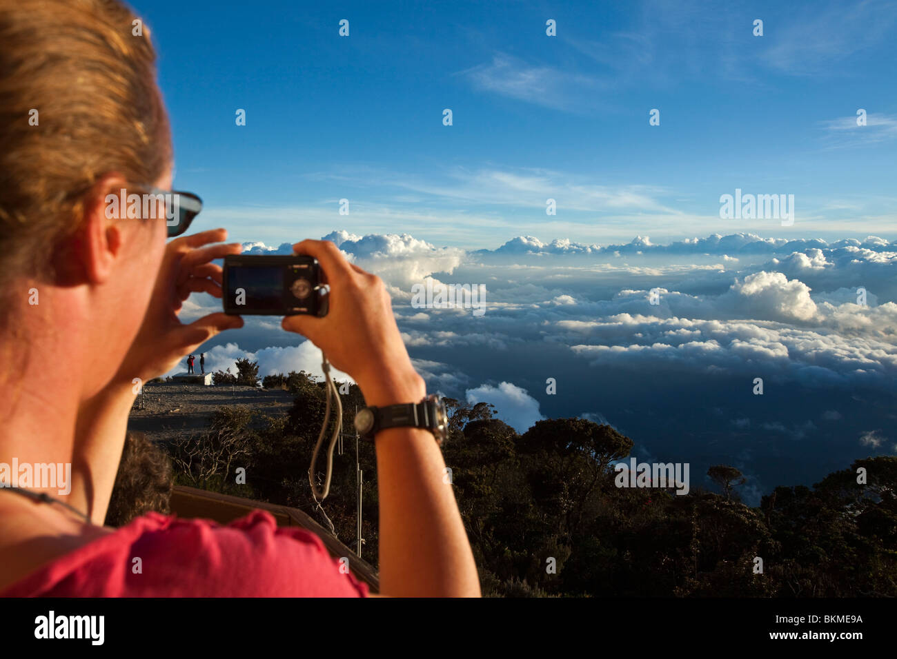 A woman photographs the view from Laban Rata resthouse on Mt Kinabalu ...