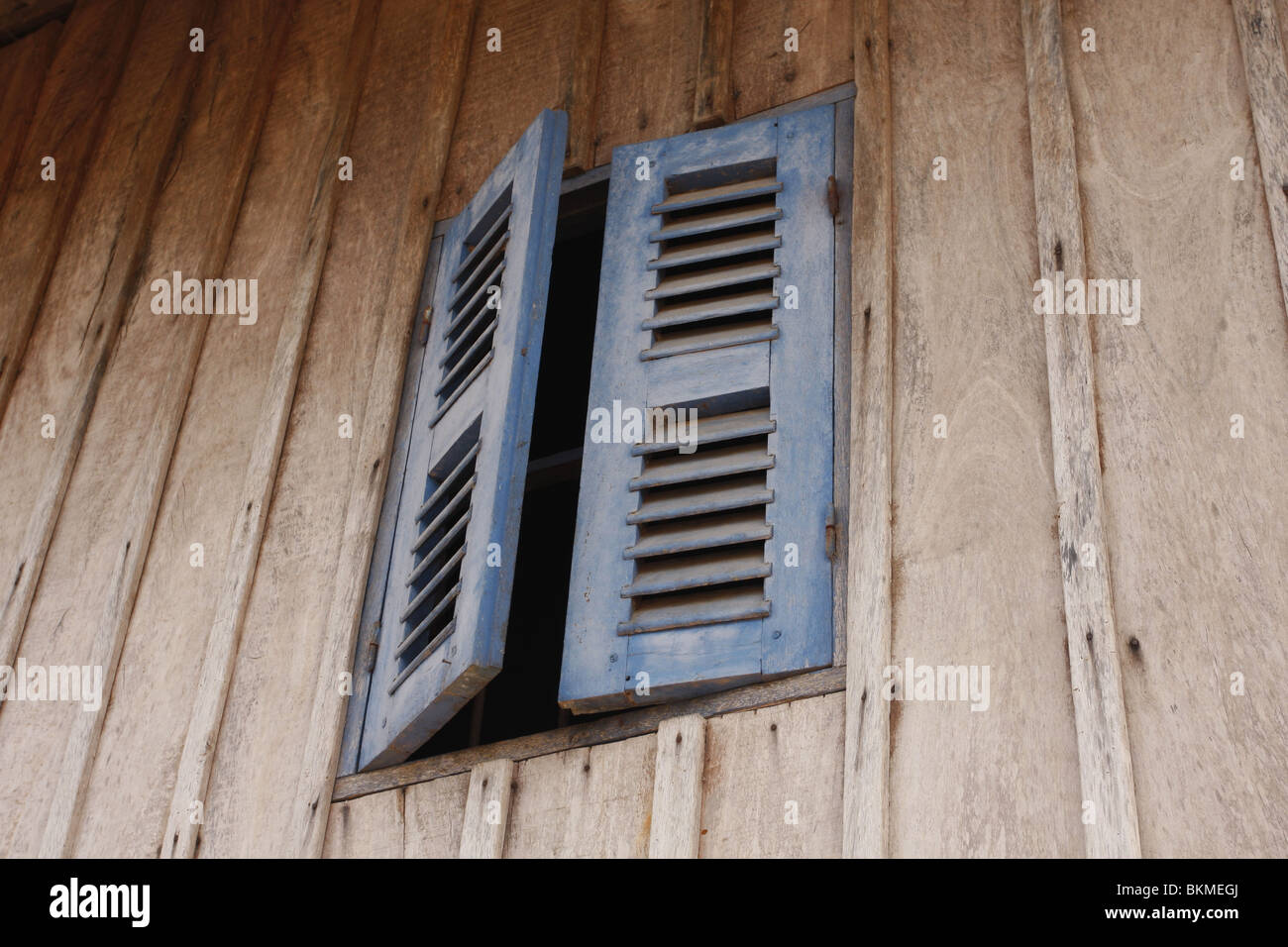 Wooden shutters in a traditional Khmer village house near Kampot ...