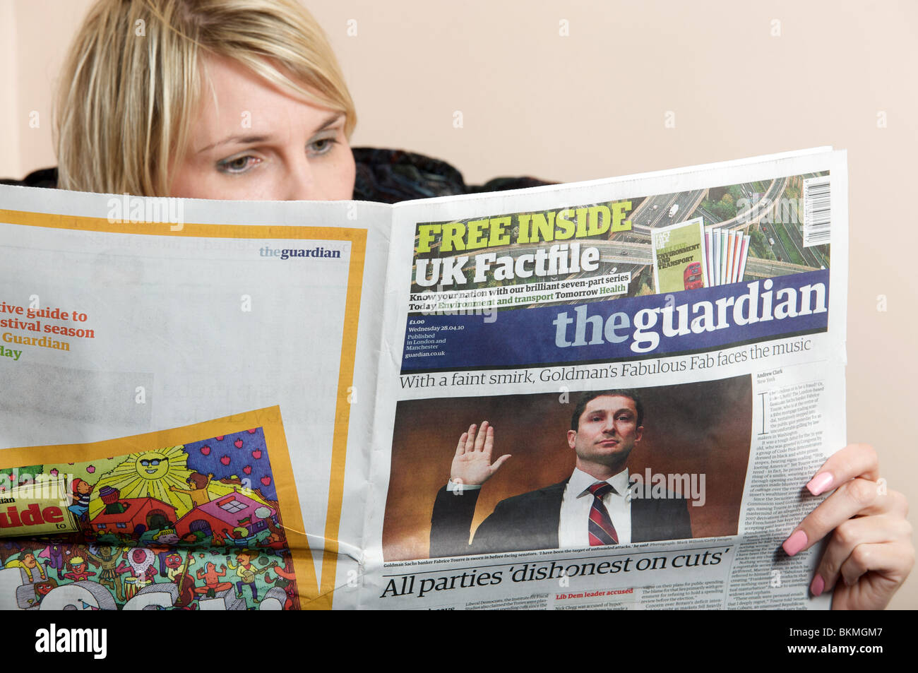 Woman reading a copy of the Guardian newspaper Stock Photo - Alamy