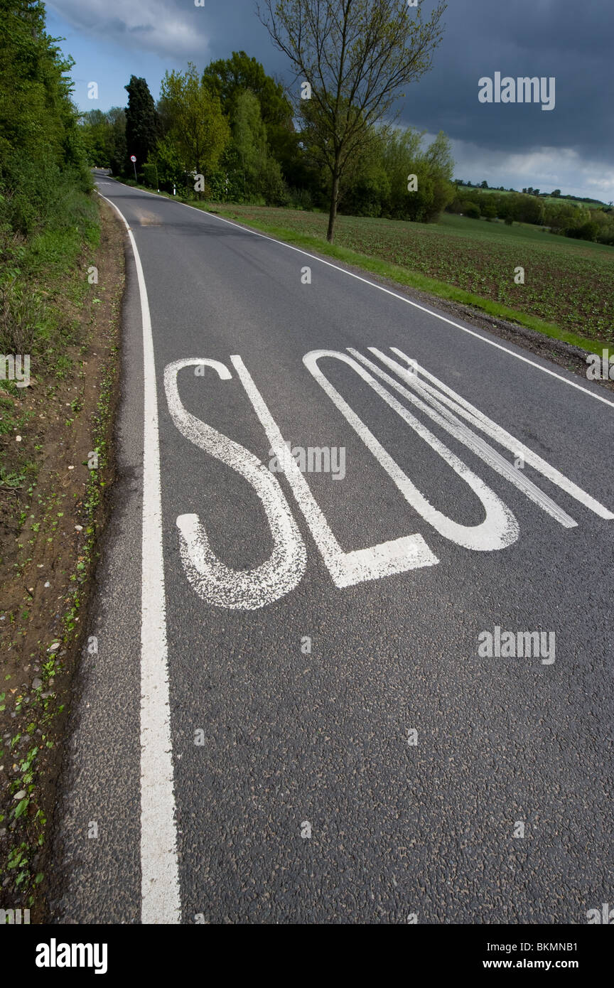 Narrow country road with slow sign, road signage and precautions on ...