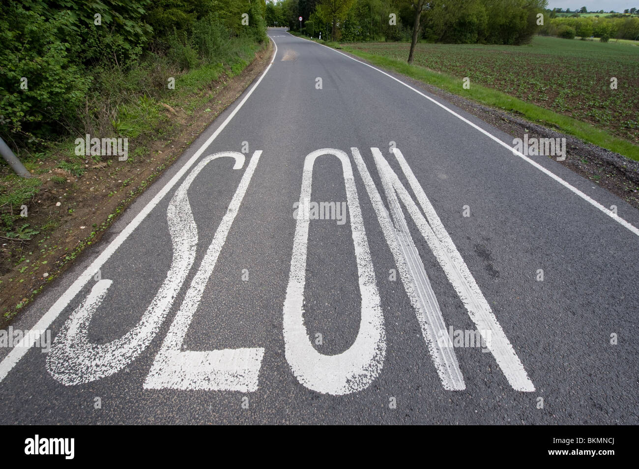 Narrow country road with slow sign, road signage and precautions on ...